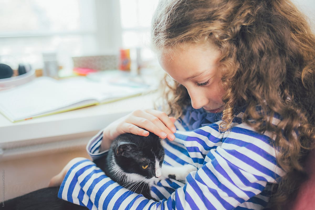 "Girl Playing With Her Kitten" by Stocksy Contributor "Lumina" - Stocksy