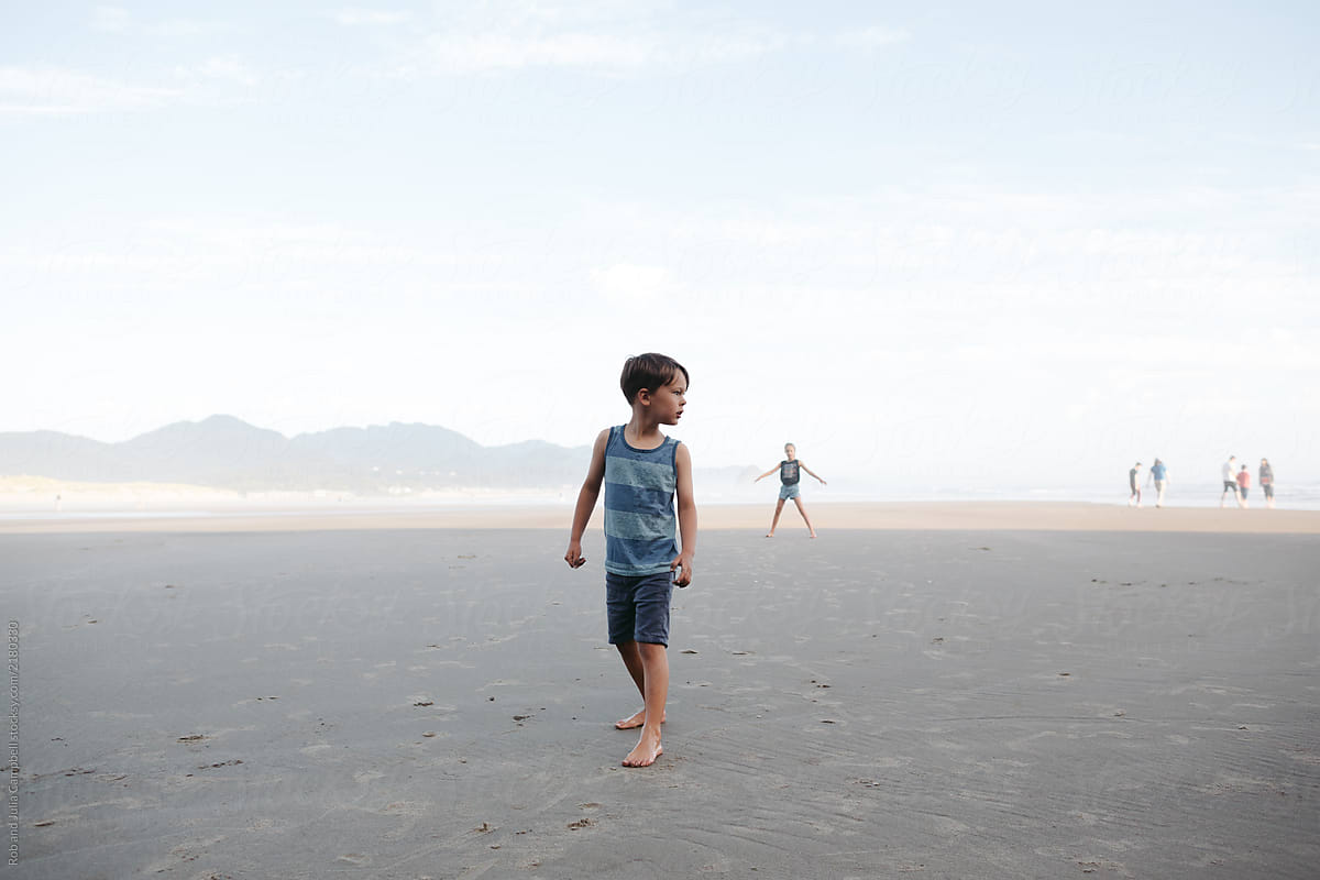 "Young Boy Looking Around At The Beach." by Stocksy Contributor "Rob ...