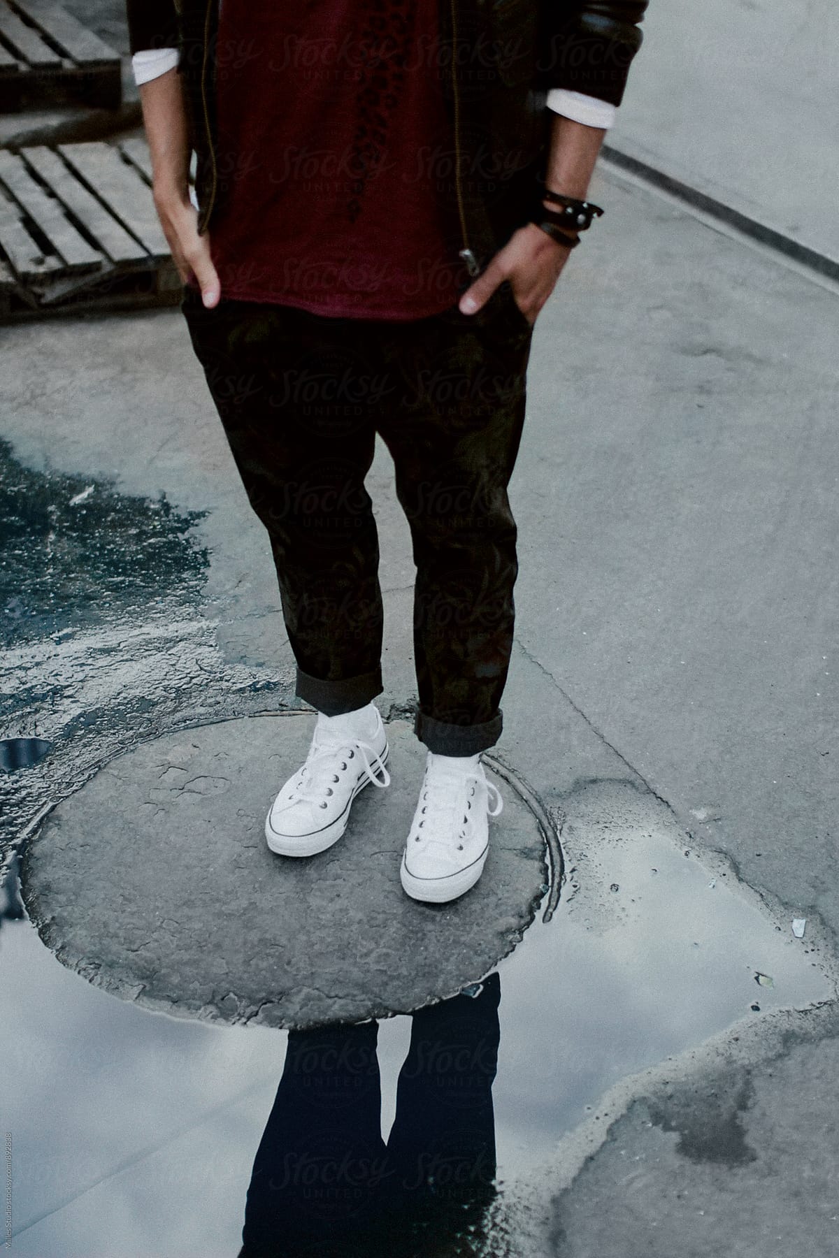 "Man Standing On Pavement" by Stocksy Contributor "Milles Team" - Stocksy