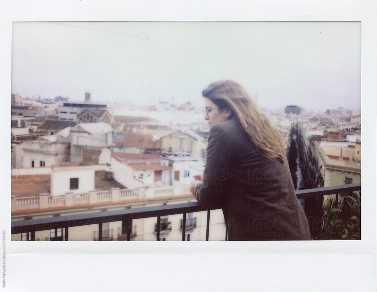 "Woman On Balcony." by Stocksy Contributor "Guille Faingold" - Stocksy