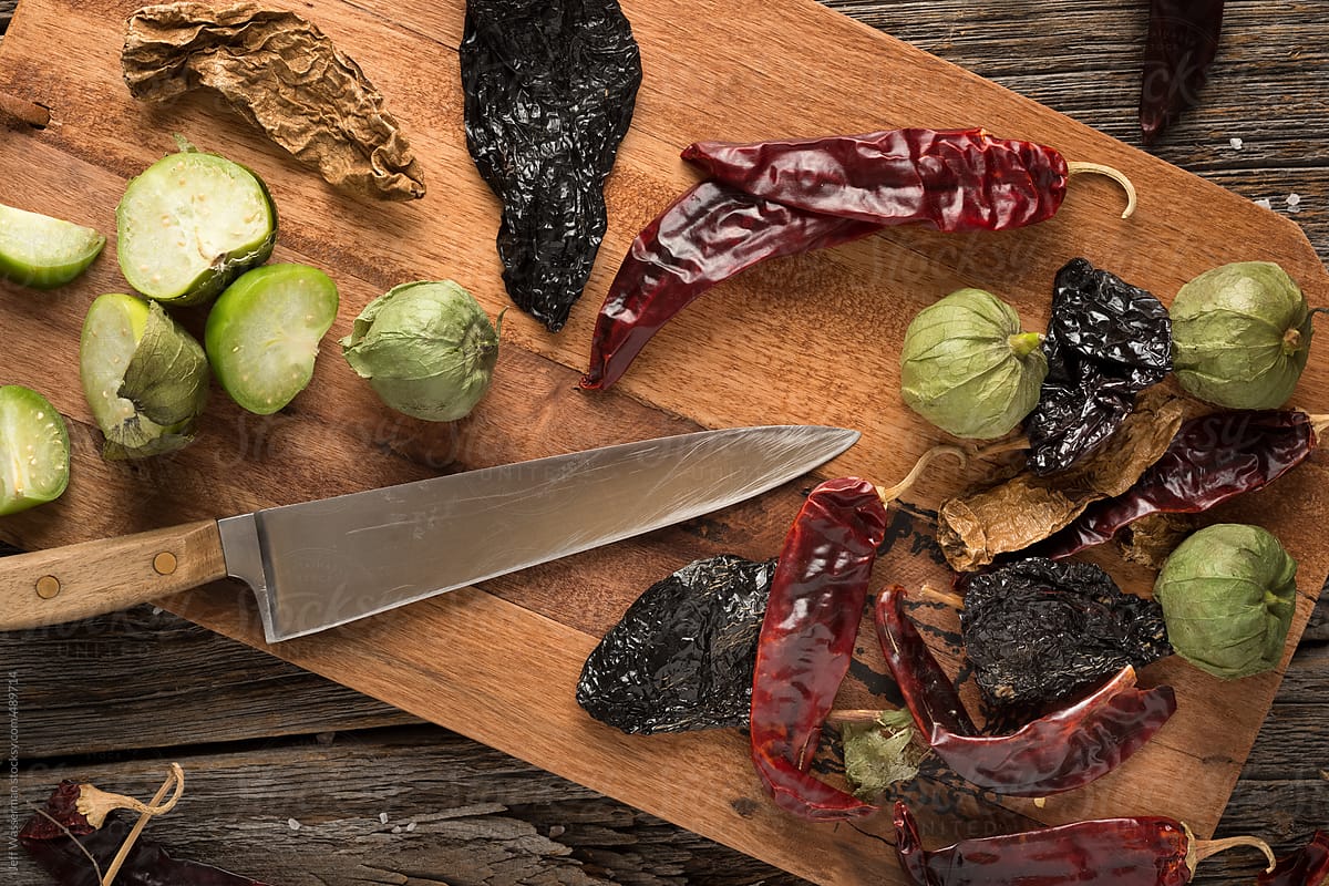 Mexican Food Ingredients Tomatillos With Chile Peppers By Stocksy Mexican Food Ingredients Tomatillos With Chile Peppers By Stocksy