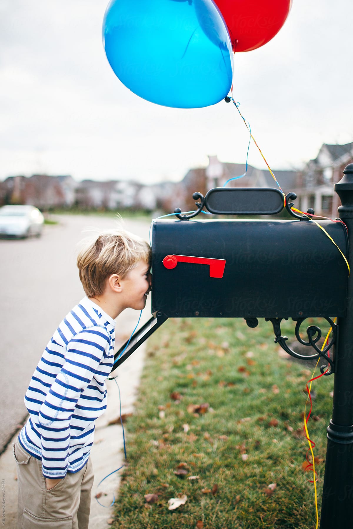 "Child Peeking Inside Mailbox Decorated With Colorful Balloons" by ...