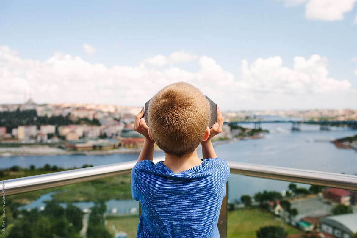 "Sightseeing Child Looks Through Fixed Binoculars Towards An Out Of ...