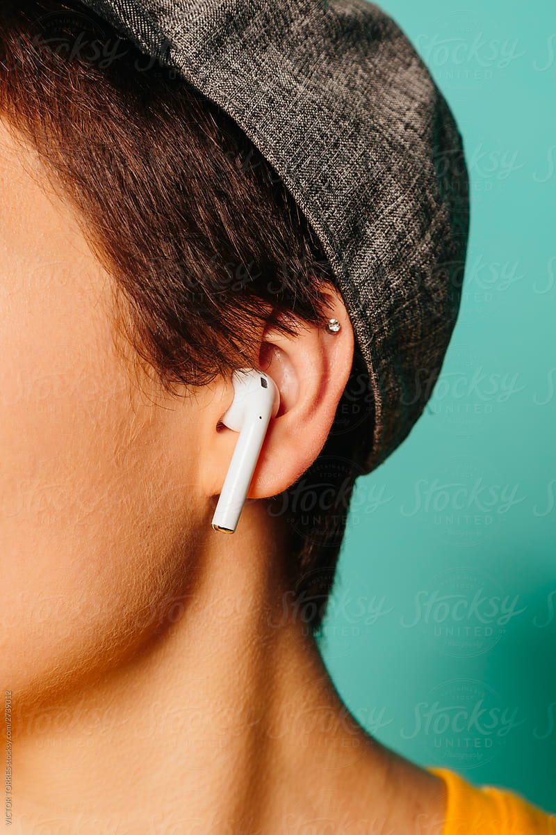 "Closeup View Of Unrecognizable Person Using A Wireless Earphone" by ...