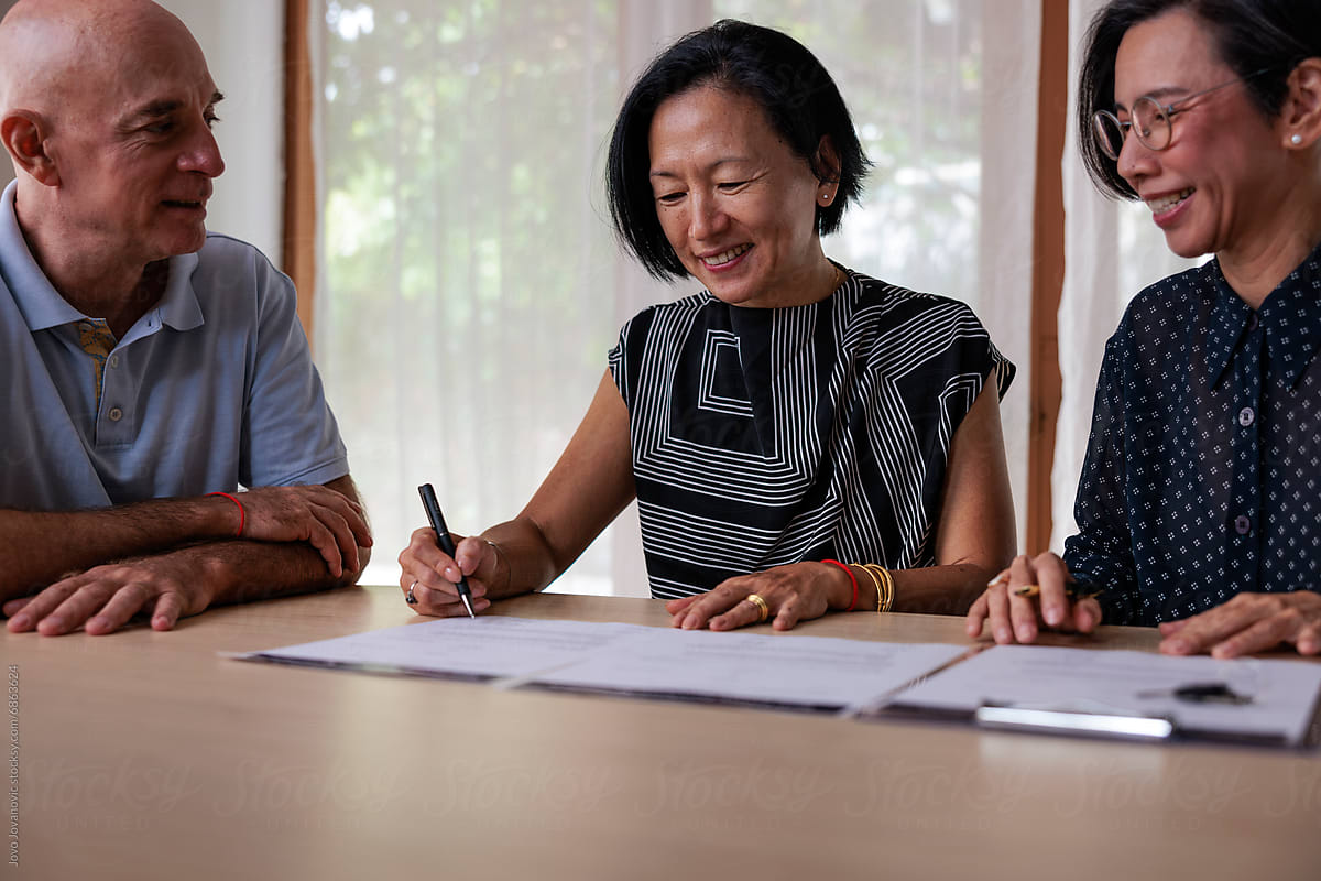"Happy Couple Signing Contract" by Stocksy Contributor "Jovo Jovanovic ...