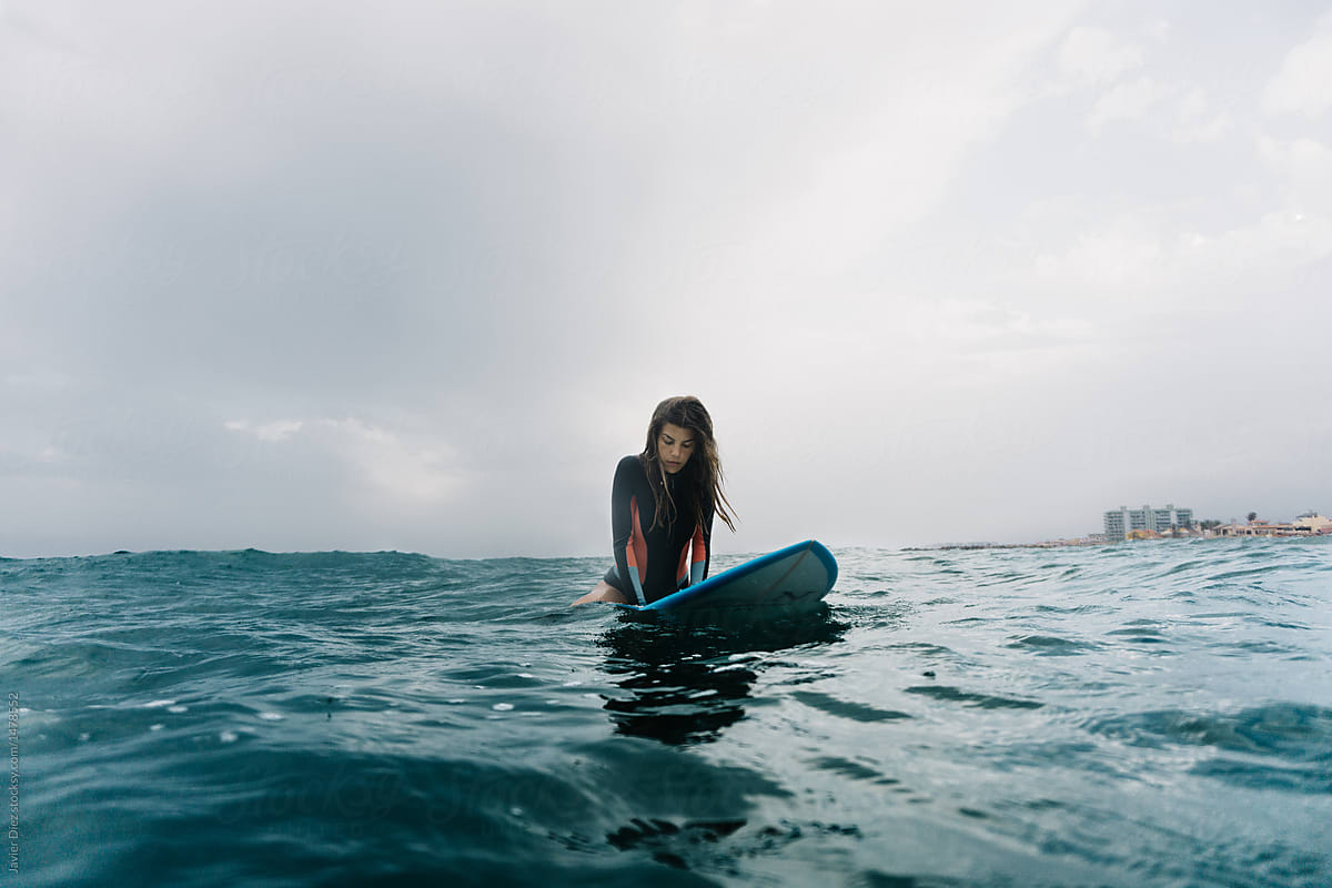 "Female Surfer On Board" by Stocksy Contributor "Javier Díez" - Stocksy