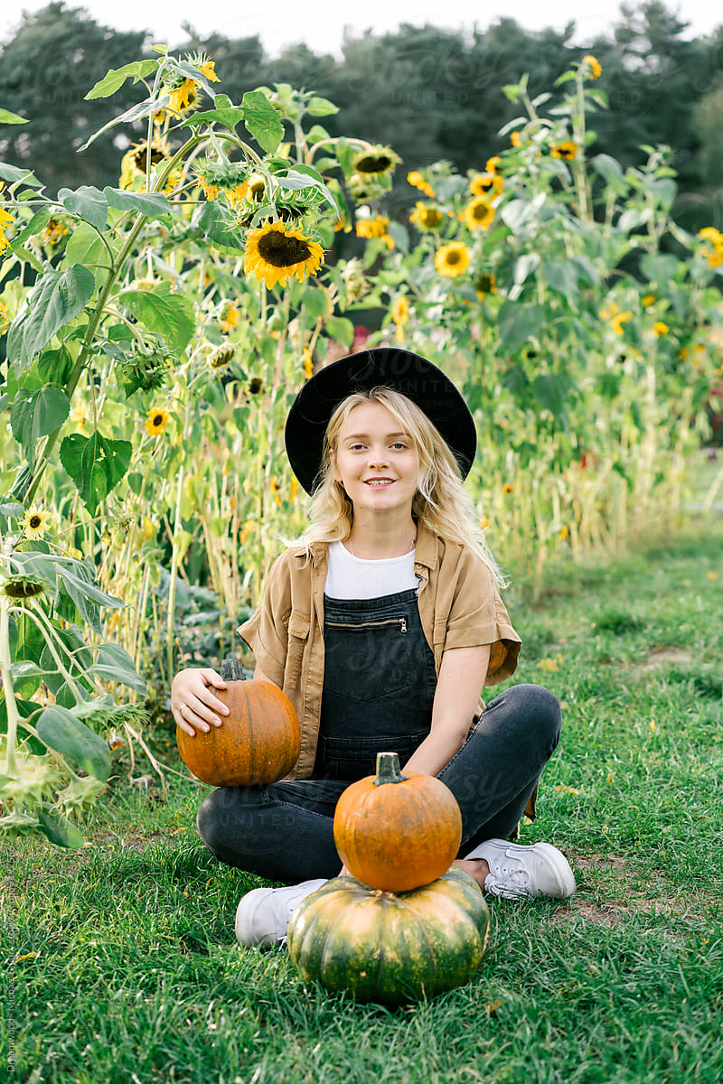 "Young Smiling Woman With Pumpkins In Field" by Stocksy Contributor ...