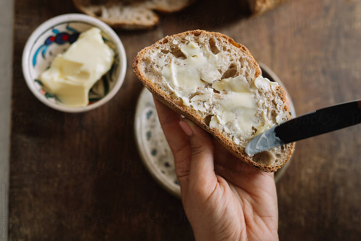 "Generous Spread Of Butter On A Rustic Bread Slice." by Stocksy ...