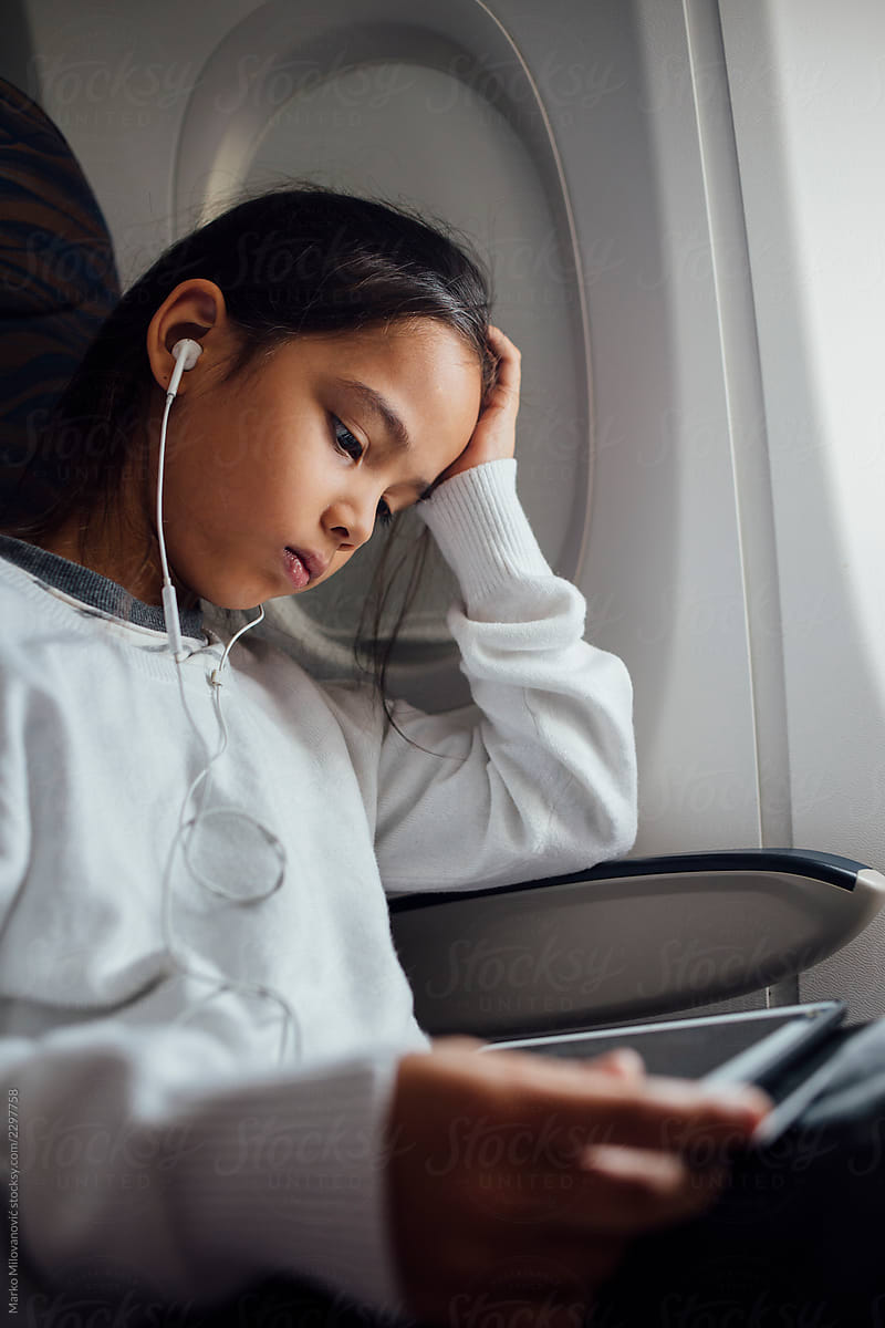 "Kid Watching A Movie On A Tablet During The Flight" by Stocksy ...