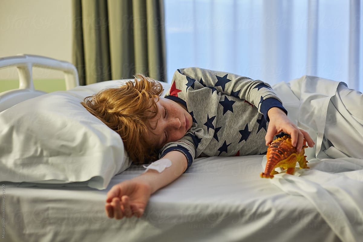 "Child Patient Lying On Bed In A Hospital Room In A Bored Mood" by ...