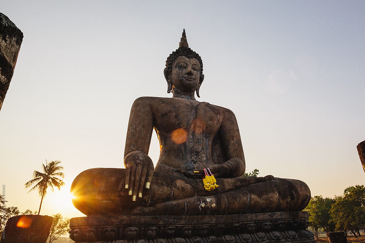 "Buddha Statue At Sunset" by Stocksy Contributor "Michela Ravasio ...