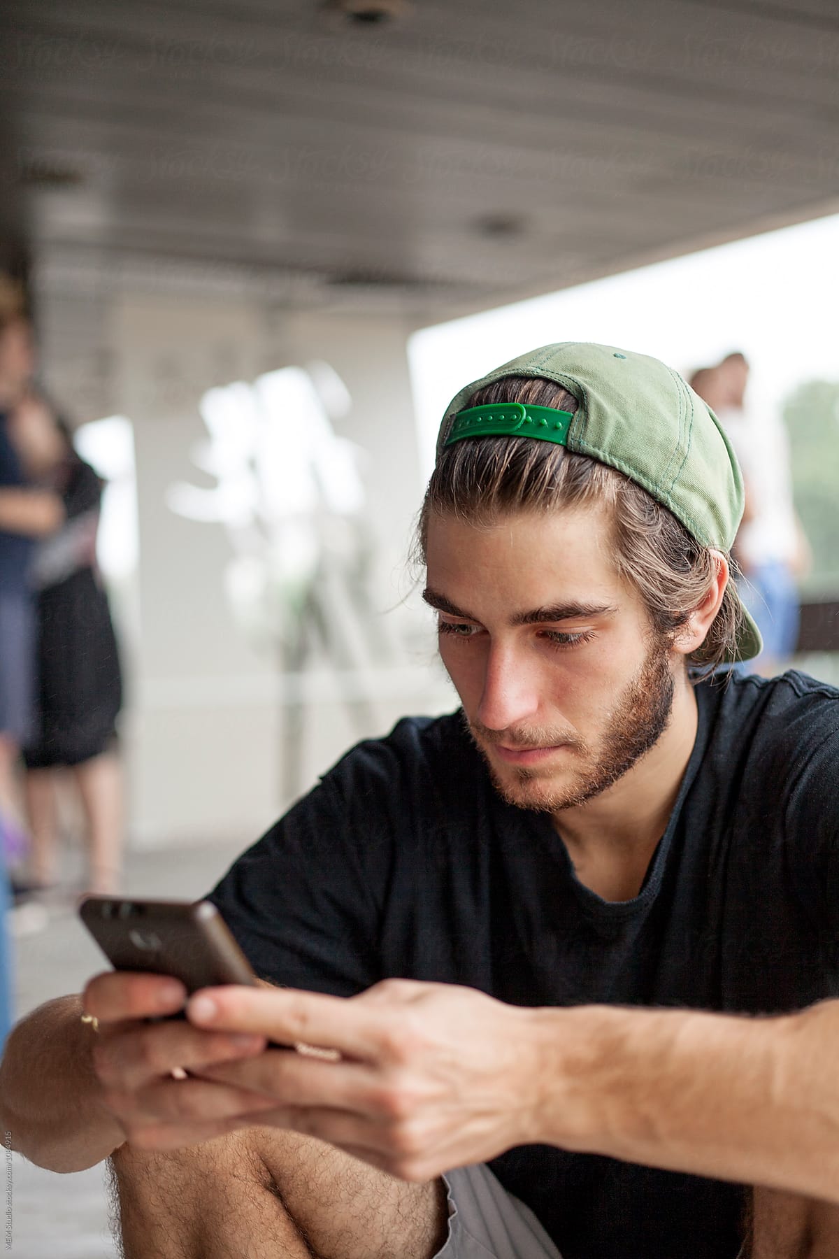 "Young Man Typing On His Phone" by Stocksy Contributor "MEM Studio ...