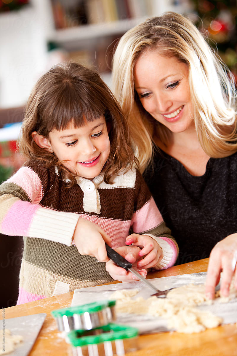 "Gingerbread: Girl Gets Cookies Off Of Cookie Sheet" by Stocksy ...