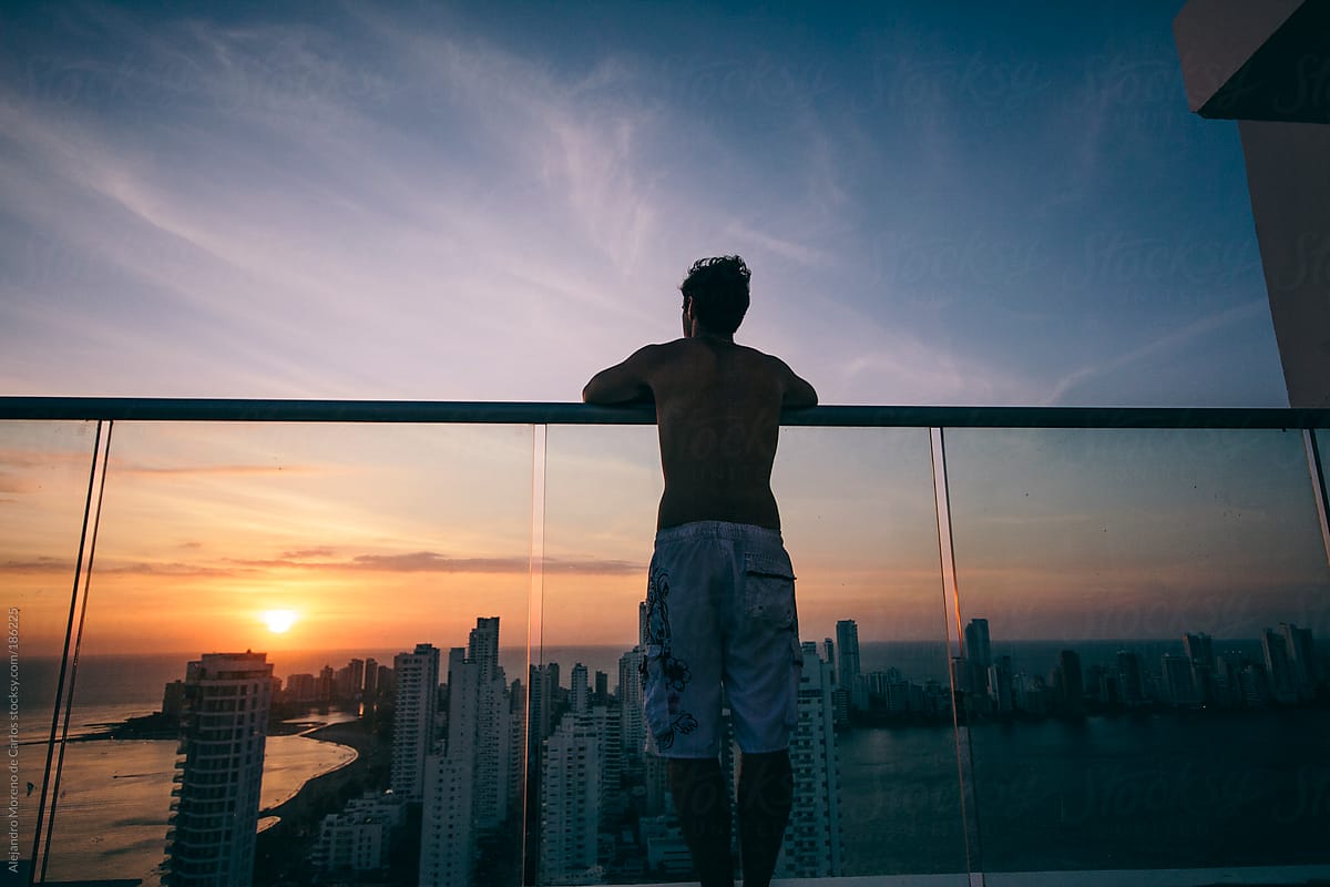 "Young Man With Swimsuit Looking From Balcony On A Hotel Rooftop On The ...