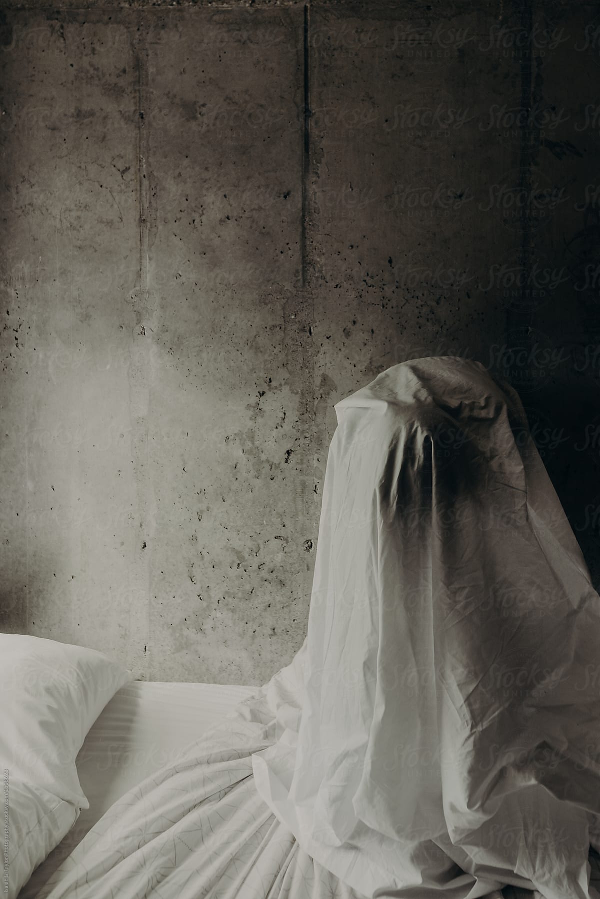 "A Sad Ghost Sitting Alone On A Minimal White Bed In A Cement Loft ...