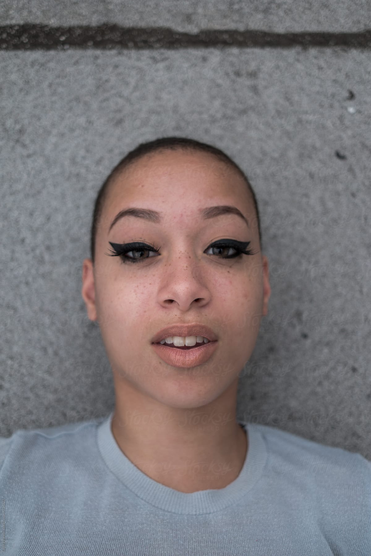  Up Close Portrait Of A Beautiful Mixed Woman Laying Down By Stocksy