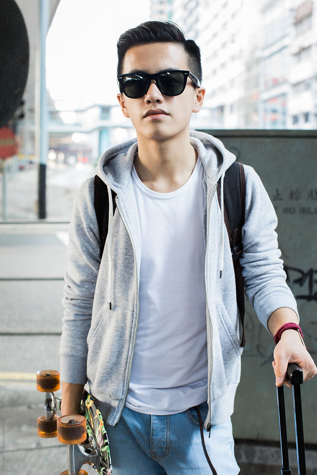 "Hip Asian Teenager With Skateboard Standing In Street Of Hong Kong" by ...