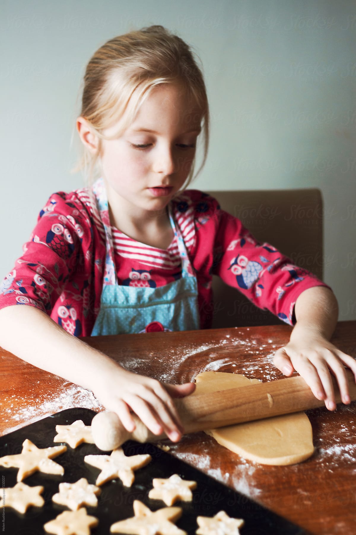 "A Little Girl Baking Biscuits" by Stocksy Contributor "Helen Rushbrook ...