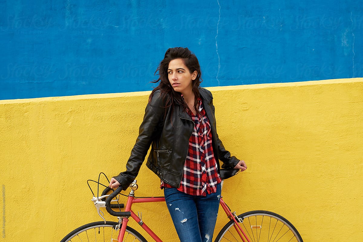 "Woman Standing Beside Her Bicycle" by Stocksy Contributor "Guille ...