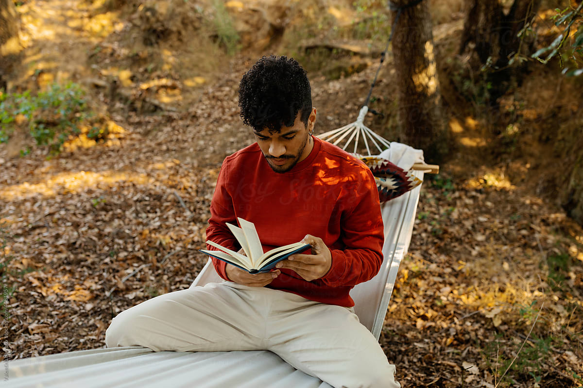 "Man Reading Outdoor" by Stocksy Contributor "Valbar STUDIO" - Stocksy