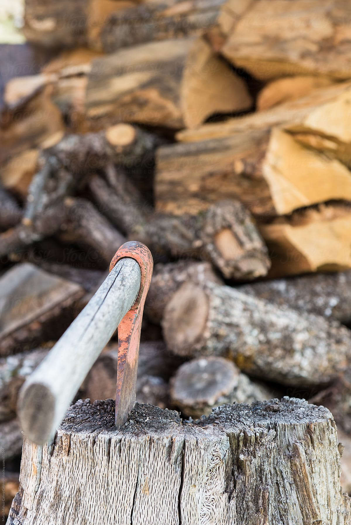 "Woodcutting Ax Stuck In A Log" by Stocksy Contributor "Marta Muñoz ...