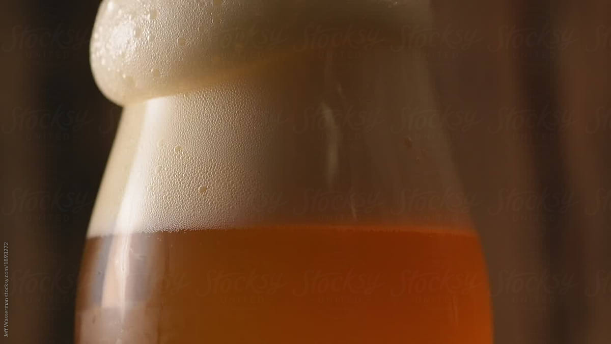"Craft Beer Overflowing" by Stocksy Contributor "Jeff Wasserman" - Stocksy