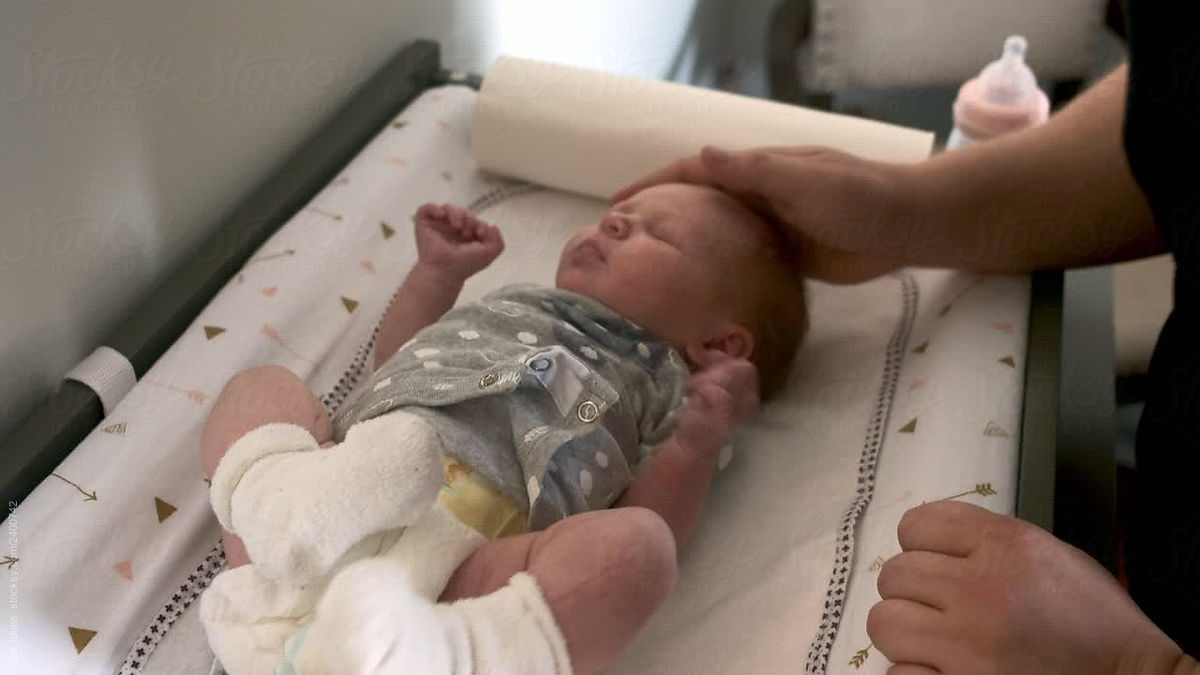 "Daddy Caressing His Newborn Baby" by Stocksy Contributor "Lea Jones ...