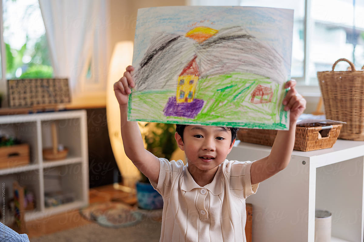 "Boy Proudly Displays His Crayon Drawing Of A Landscape." by Stocksy ...