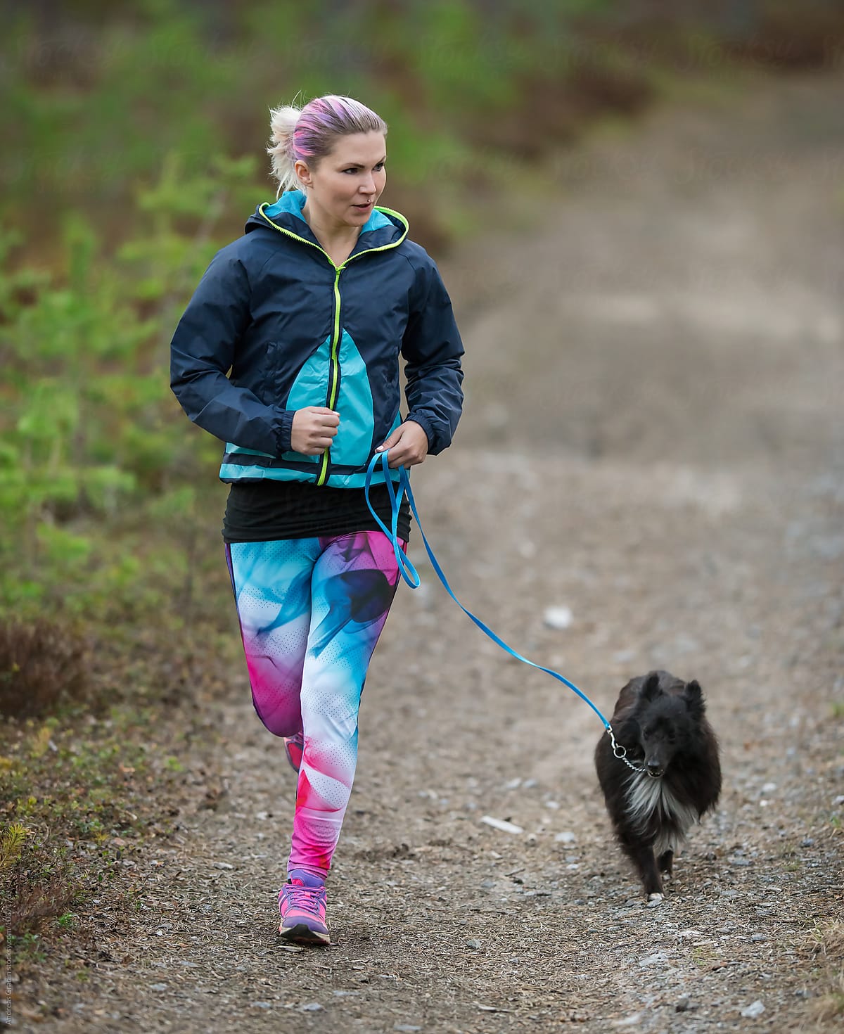 "Jogging Woman And Dog" by Stocksy Contributor "Andreas Gradin" - Stocksy