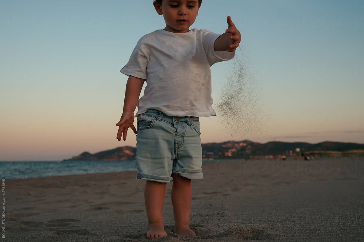 "Crop Toddler Throwing Sand On Beach" by Stocksy Contributor ...