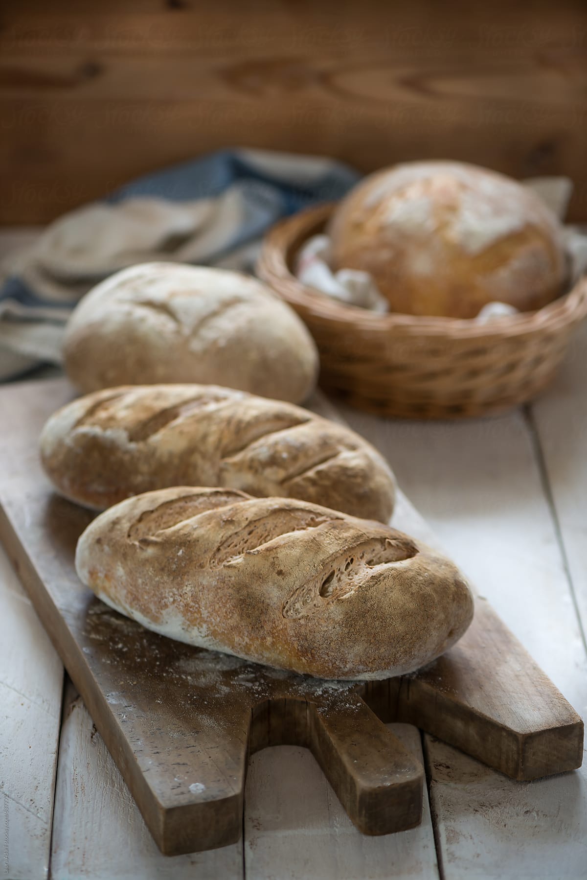 "Freshly Baked Loaves Of Bread On Cutting Board" by Stocksy Contributor ...