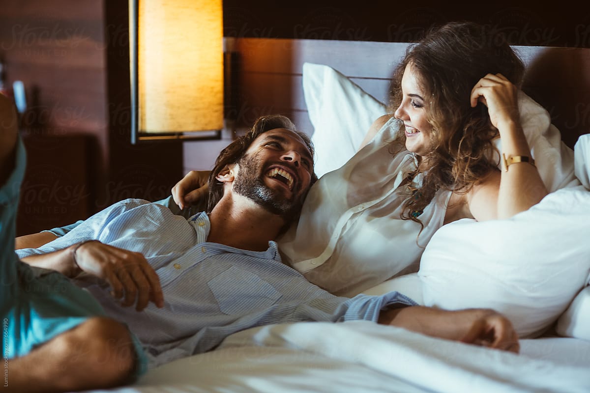 "Happy Couple Relaxing In A Hotel Room" by Stocksy Contributor "Lumina ...