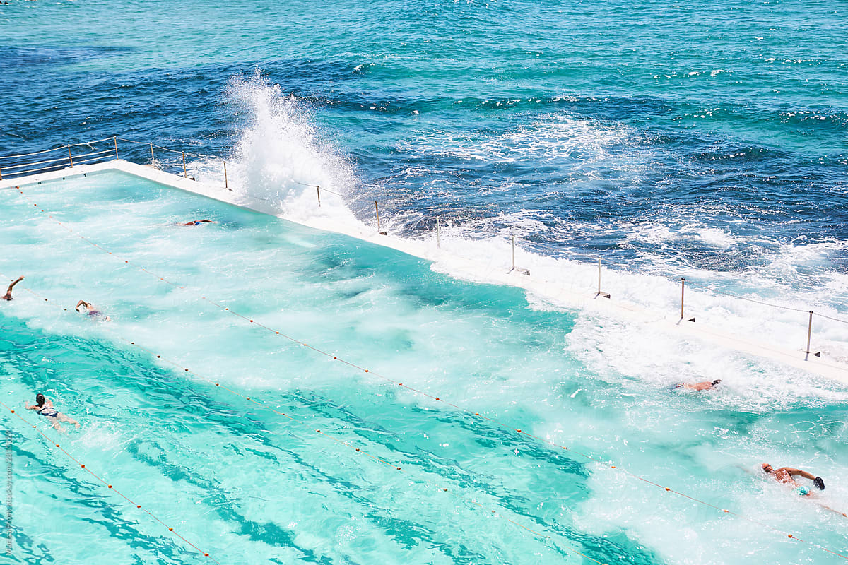 "Swimmers In Azure Ocean Pool" by Stocksy Contributor "Mon C Pronk ...