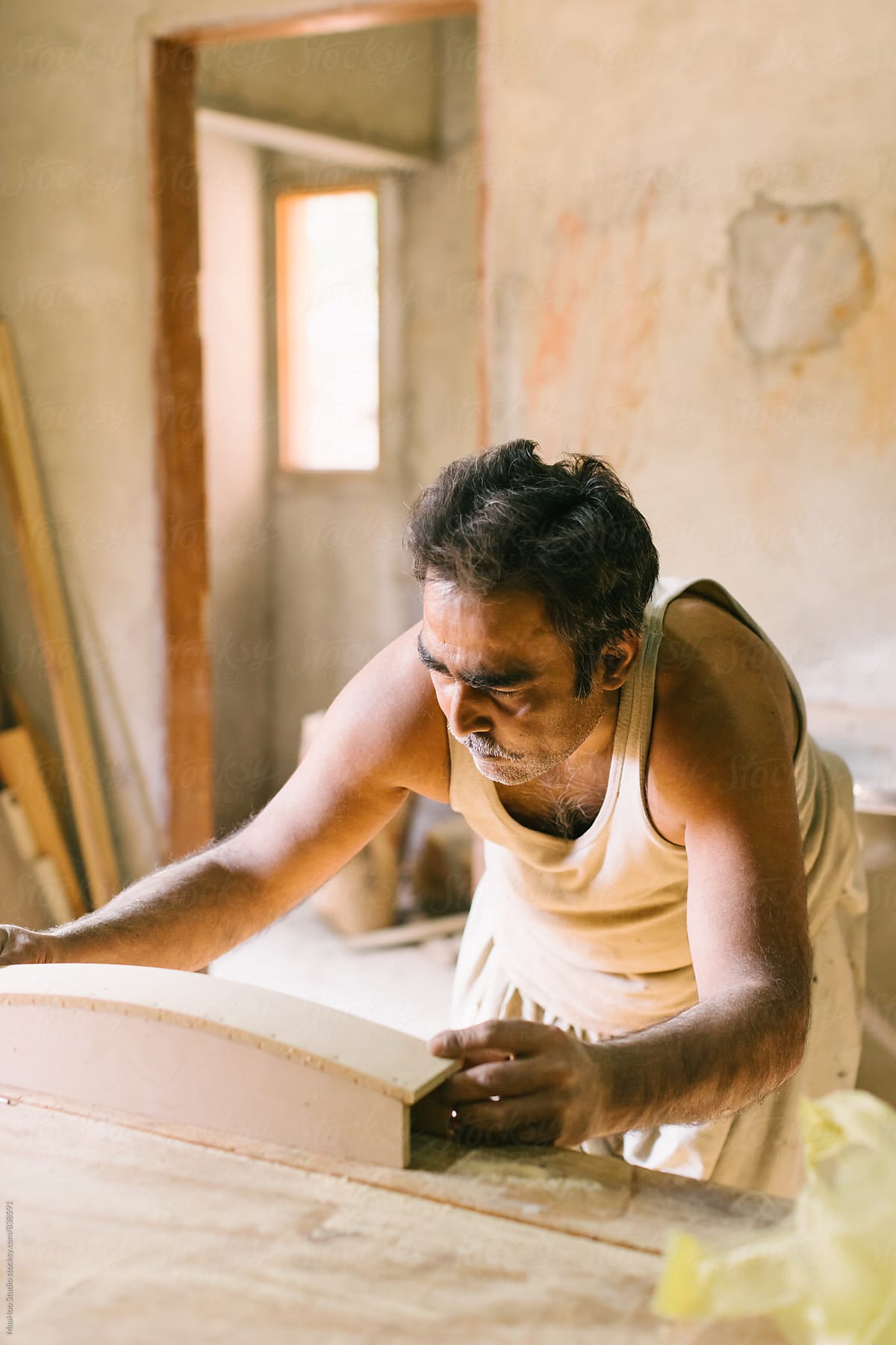 "Carpenter Looking At Wooden Plank" by Stocksy Contributor "MaaHoo ...