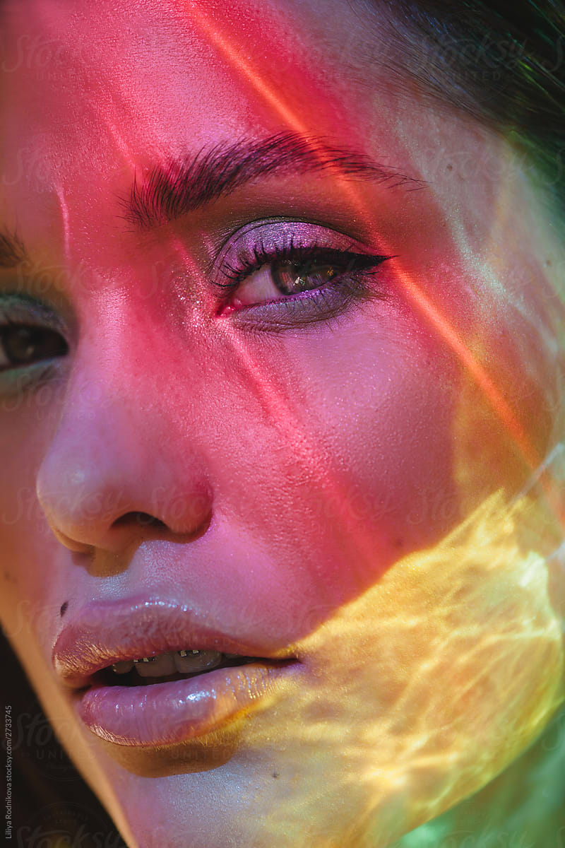"Colorful Lights On Woman Face" by Stocksy Contributor "Liliya ...