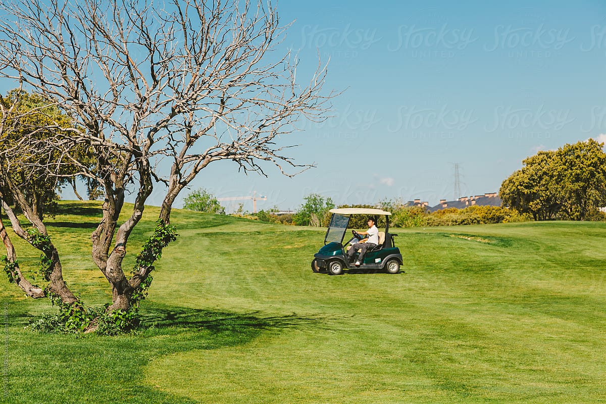 "Golfer Driving A Golf Cart" by Stocksy Contributor "VICTOR TORRES ...