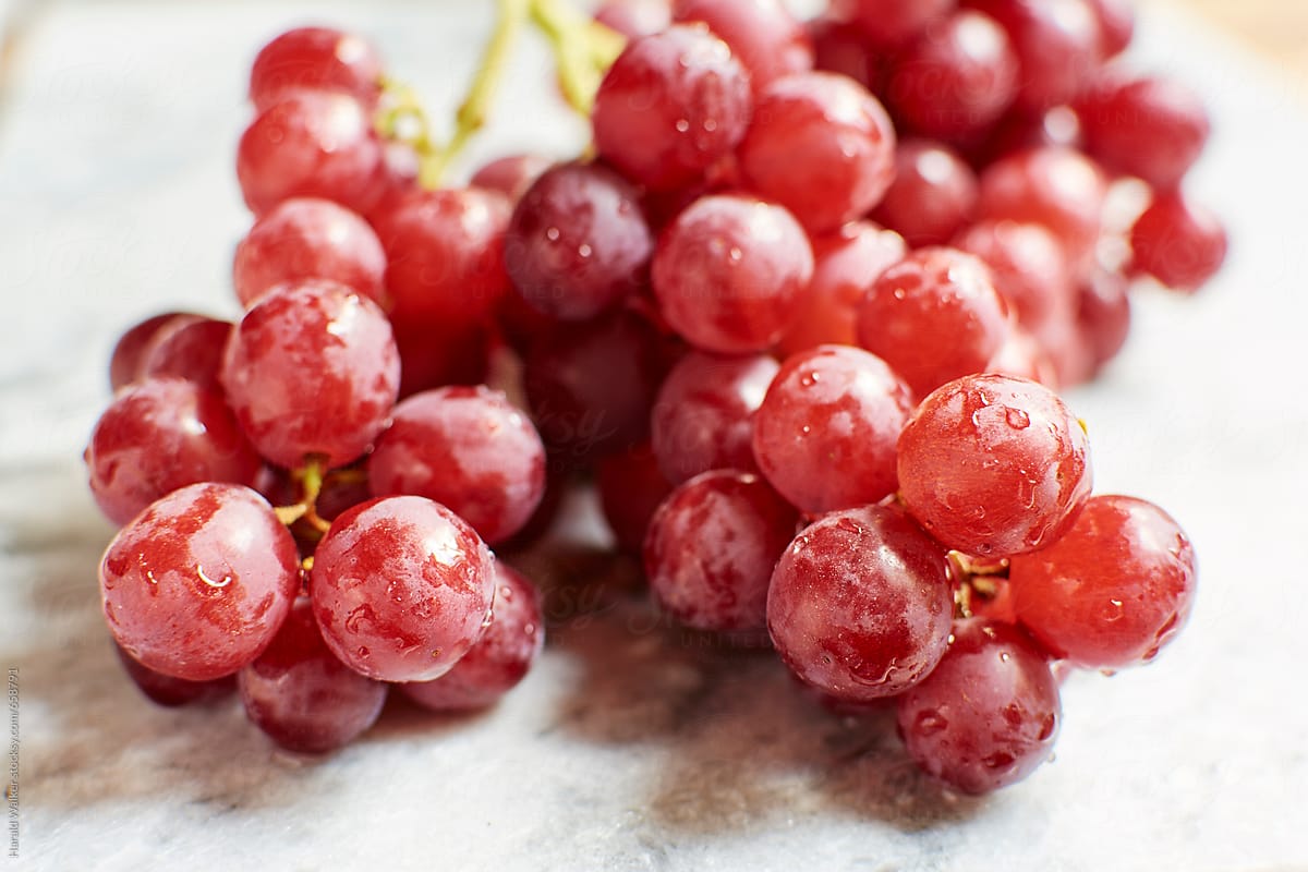 "Red Grapes On Marble" by Stocksy Contributor "Harald Walker" - Stocksy