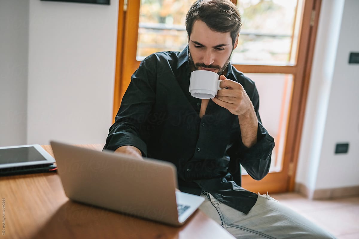 "Young Man Using A Laptop Sitting At Home" by Stocksy Contributor ...