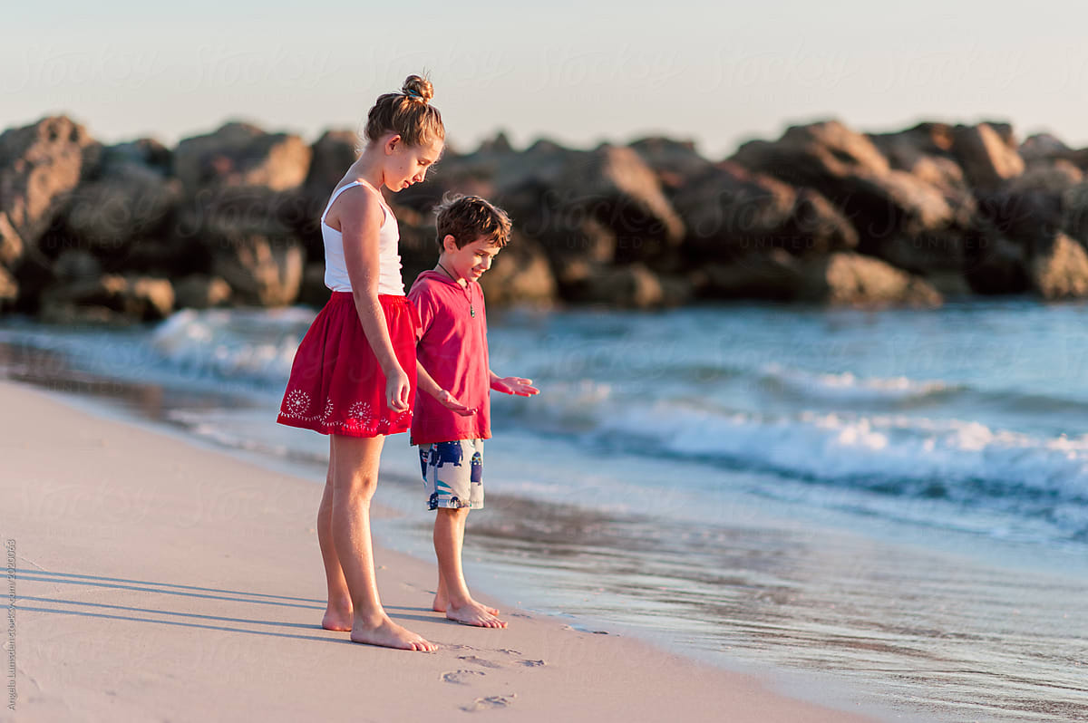 "Brother And Sister Chatting At The Beach At Sunset" by Stocksy ...