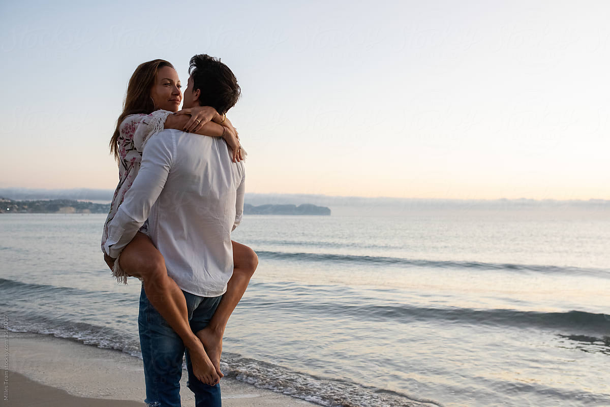 Man Carrying Woman Near Waving Sea By Stocksy Contributor Milles Man Carrying Woman Near Waving Sea By Stocksy Contributor Milles