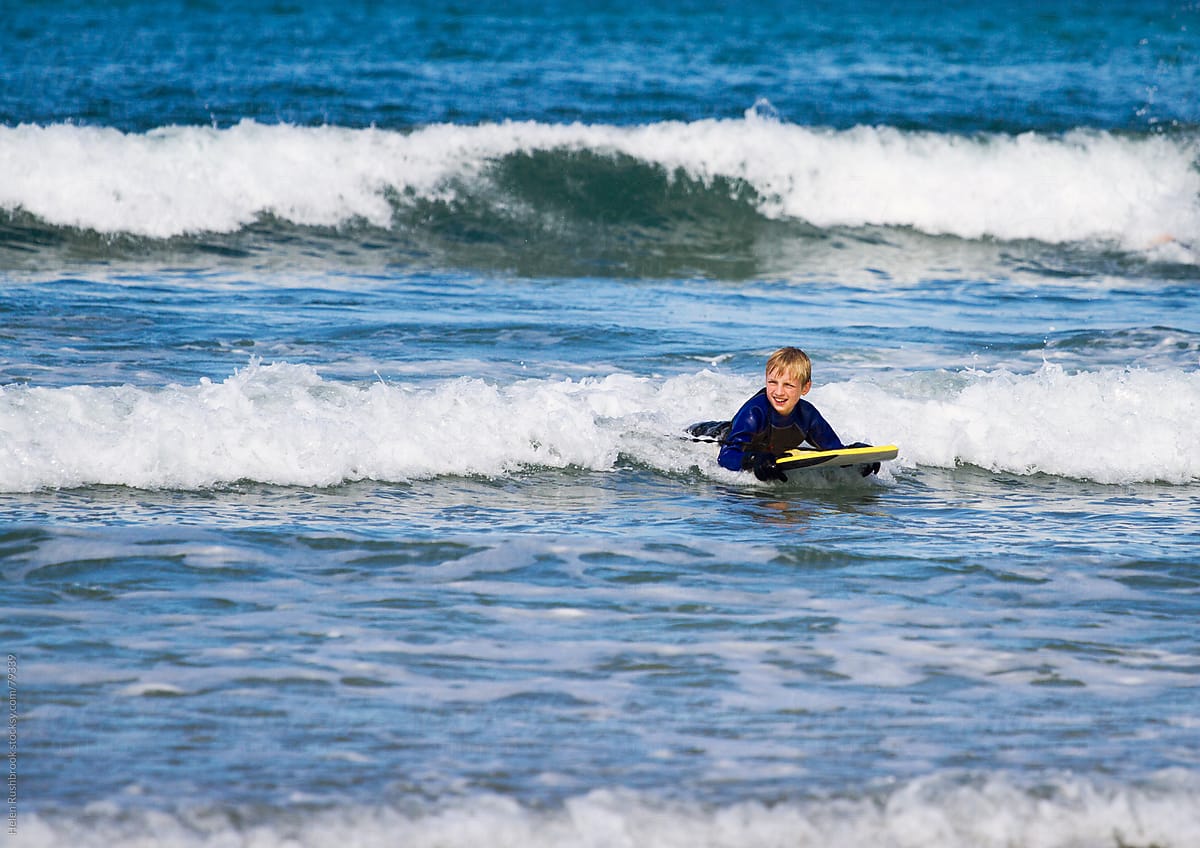 "Pre-teen Boy Body Boarding." by Stocksy Contributor "Helen Rushbrook ...