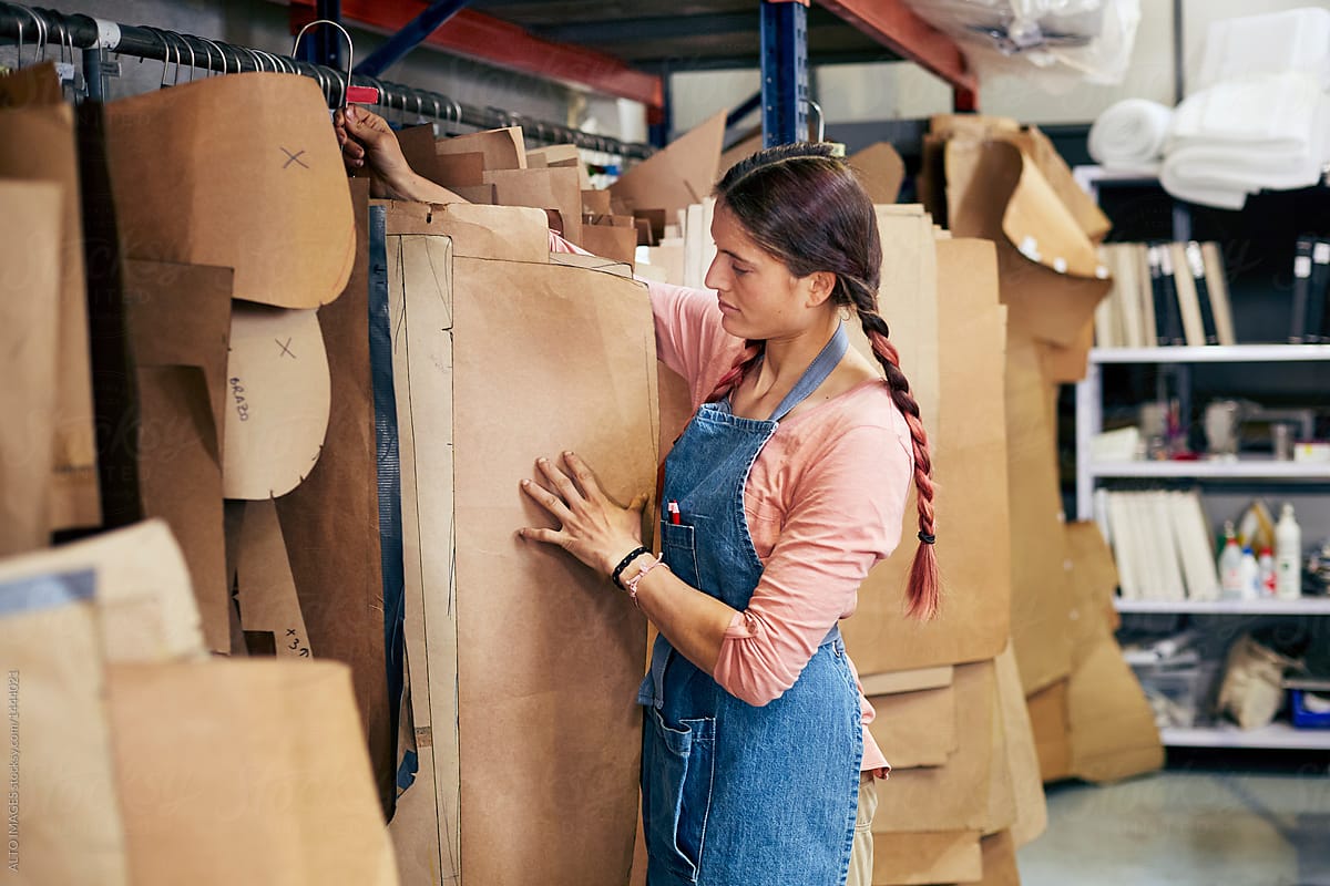 "Female Worker Selecting Cardboard Papers In Sofa Workshop" by Stocksy ...