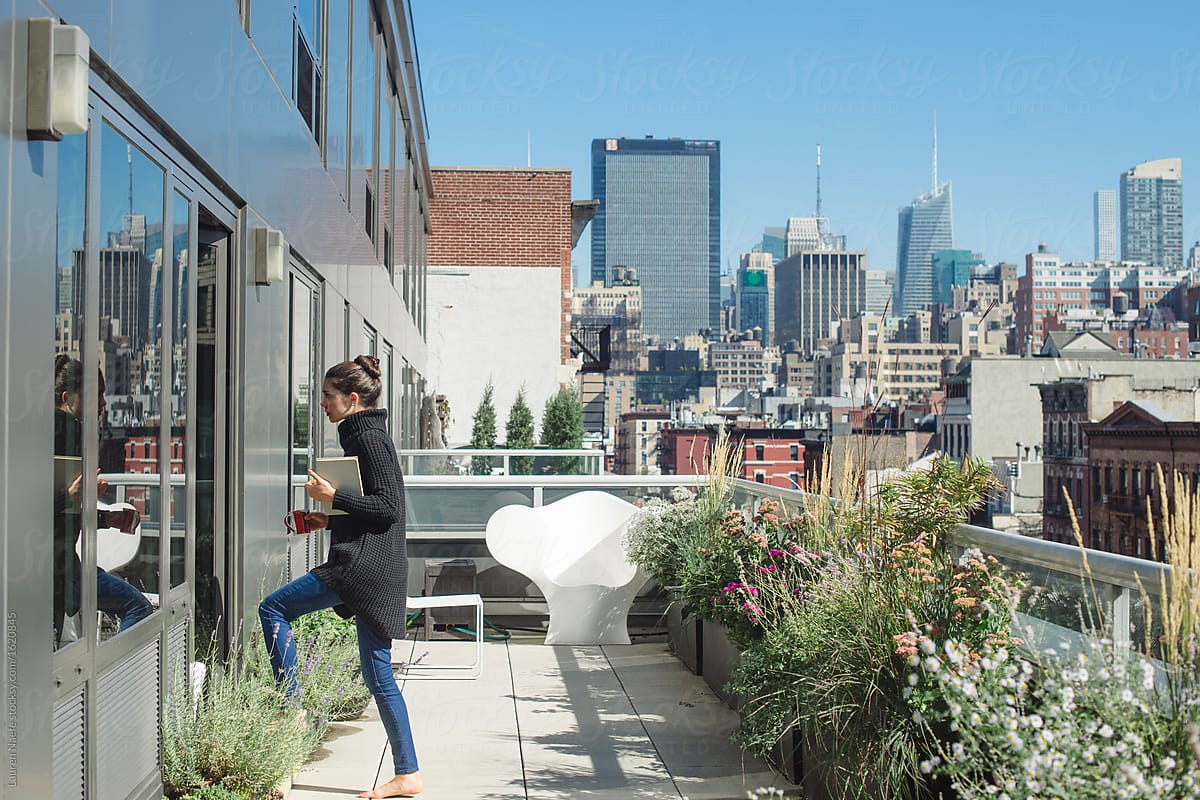 "Young Woman Walking Into Home From Balcony" by Stocksy Contributor ...