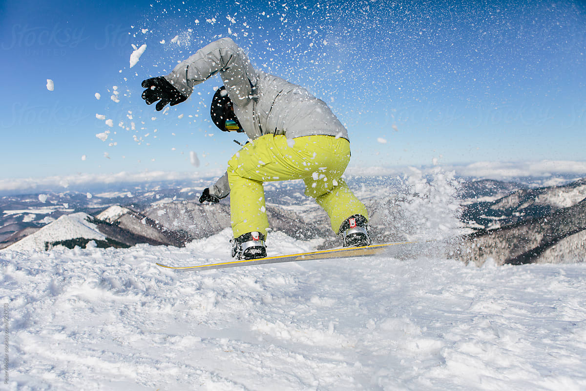 "Snowboarder Ride Down The Hill" by Stocksy Contributor "Peter Meciar ...