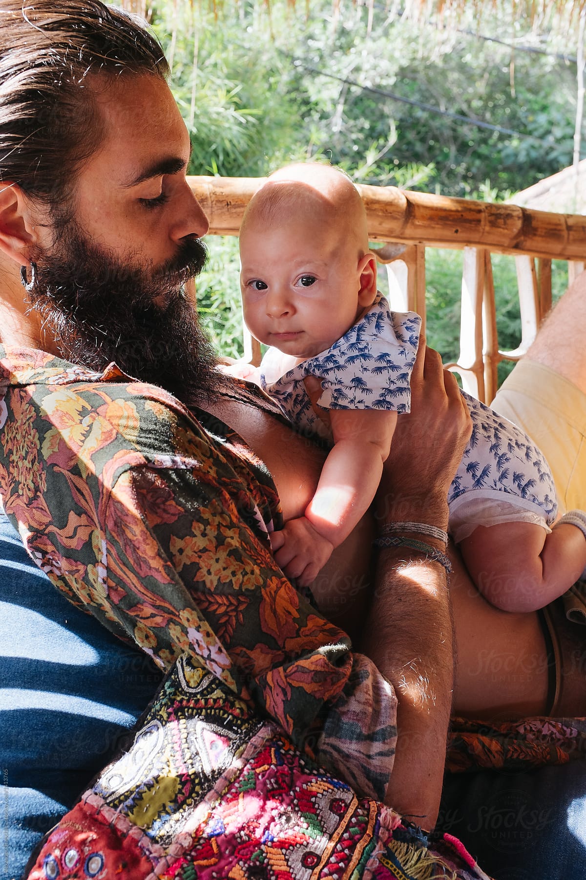 "A Father With A Long Beard Is Holding His Infant Child In His Arms" by ...