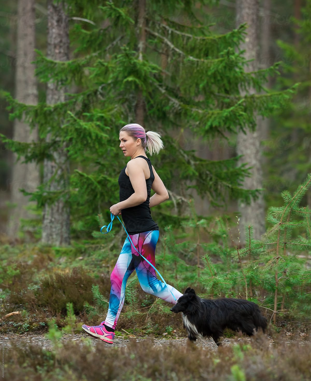 "Jogging Woman And Dog" by Stocksy Contributor "Andreas Gradin" - Stocksy
