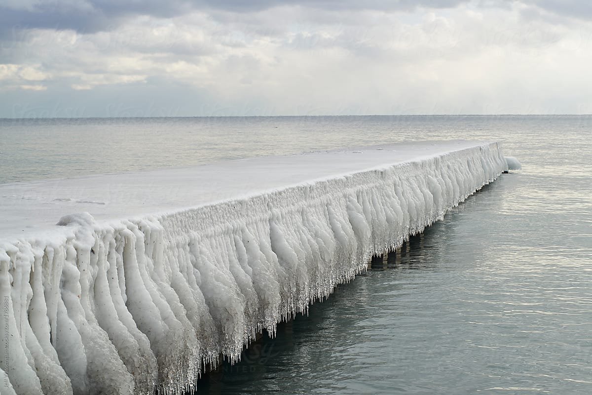 "Ice Covered Pier" by Stocksy Contributor "Jeff Wasserman" - Stocksy