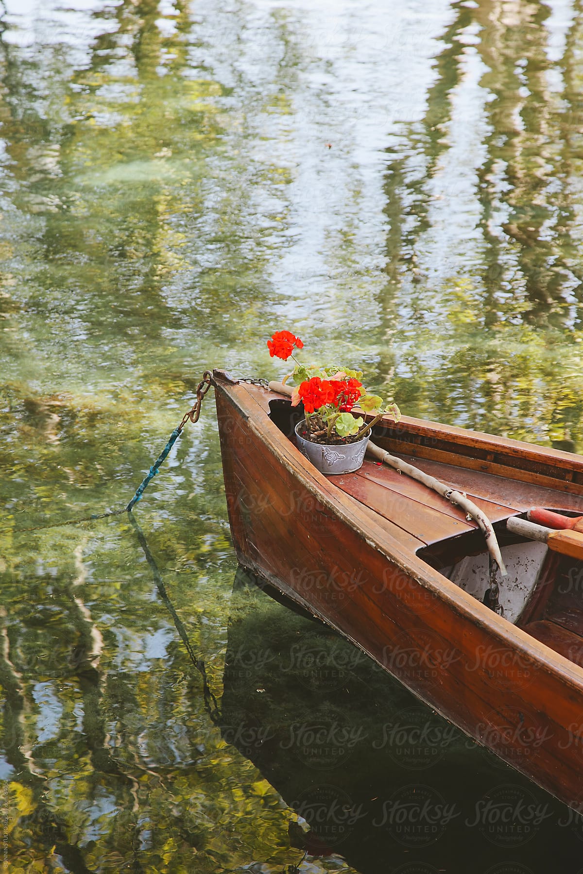 "Beautiful Wood Boat With Red Flowers On A Lake." by Stocksy ...