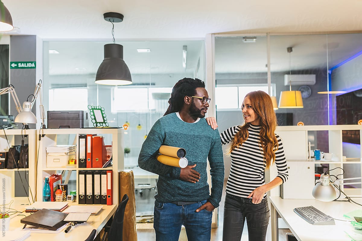 "Friend Talk In Office" by Stocksy Contributor "VICTOR TORRES" - Stocksy