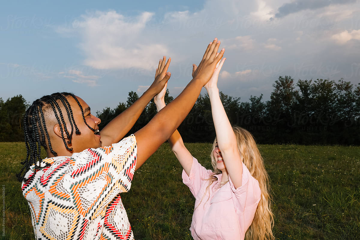 "Double High Five" by Stocksy Contributor "Studio Firma" - Stocksy